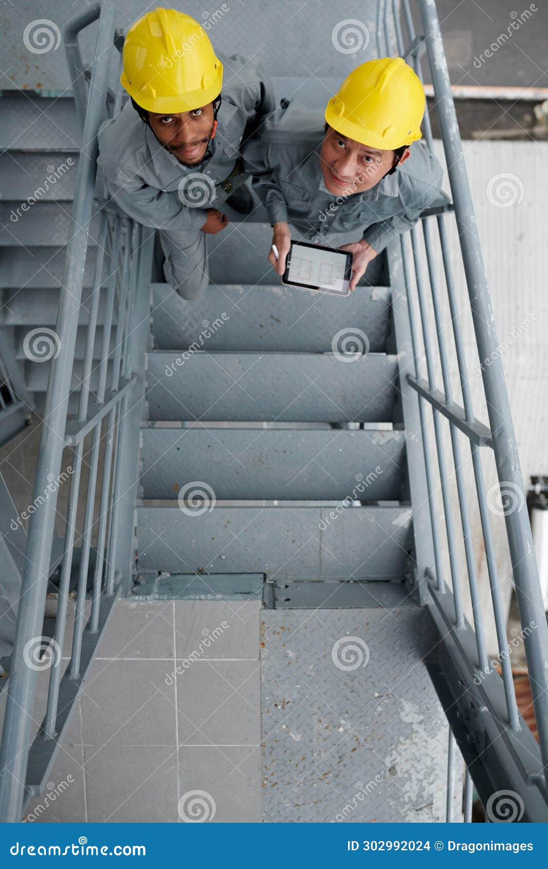 Builders Walking up Stairs stock photo. Image of industry - 302992024