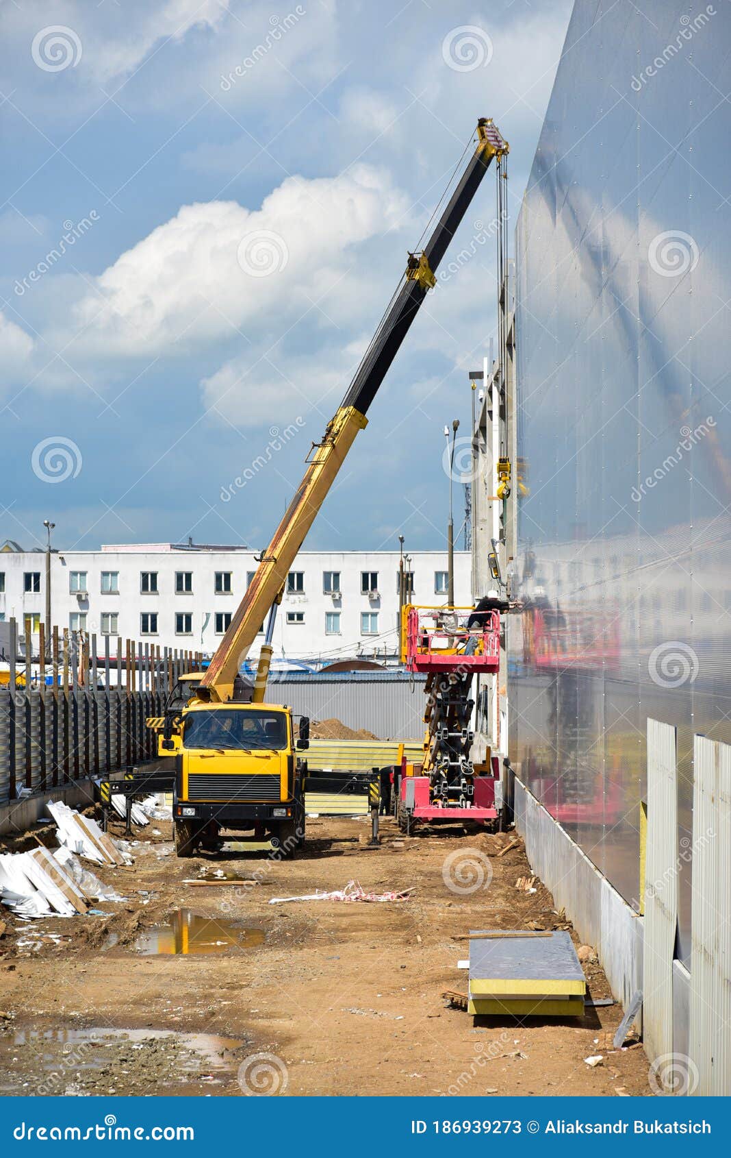 Builders Work at a Construction Site with a Cradle of a Tower Crane ...