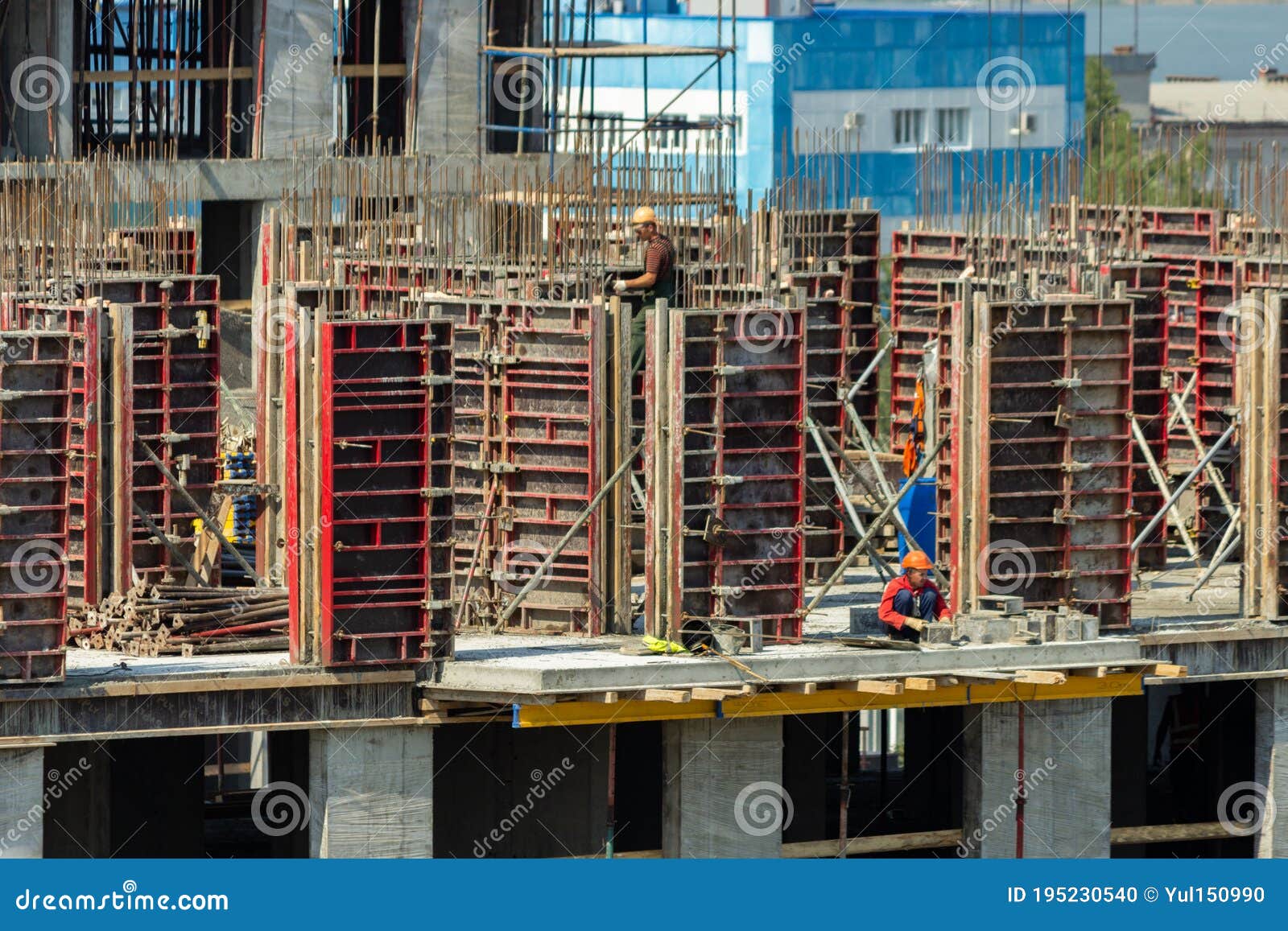 Builders are Working on a Construction Site, Assembling the Frame of a ...