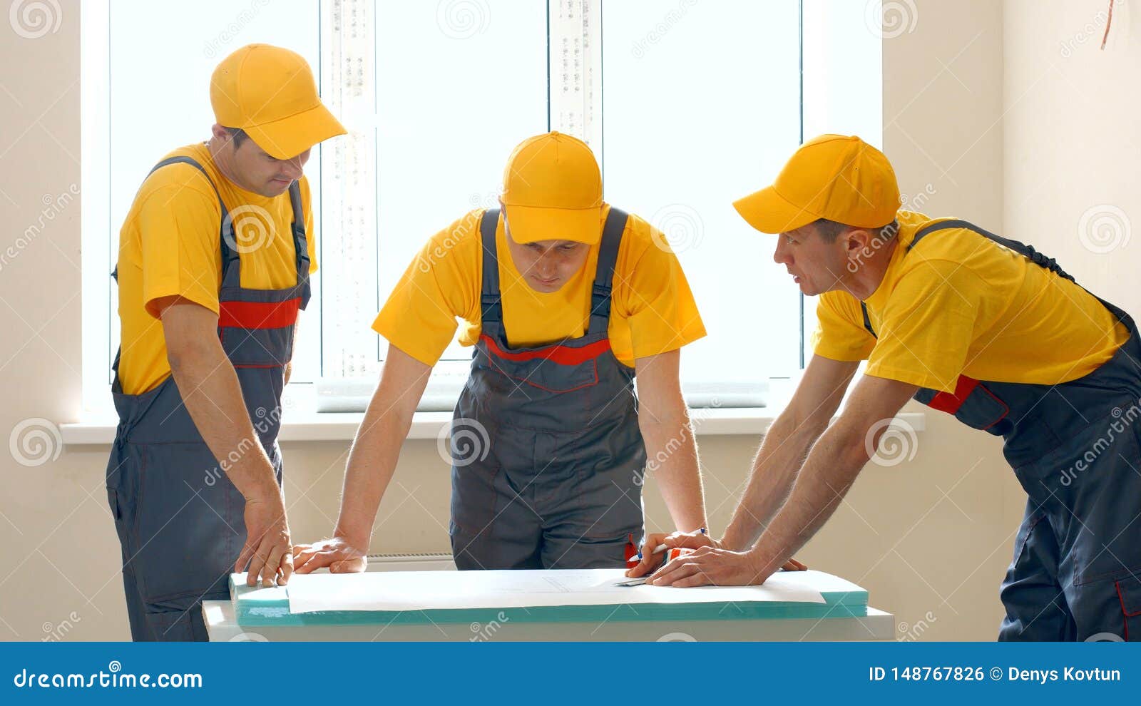 Builders Working with Documents on Construction Site. Stock Photo ...