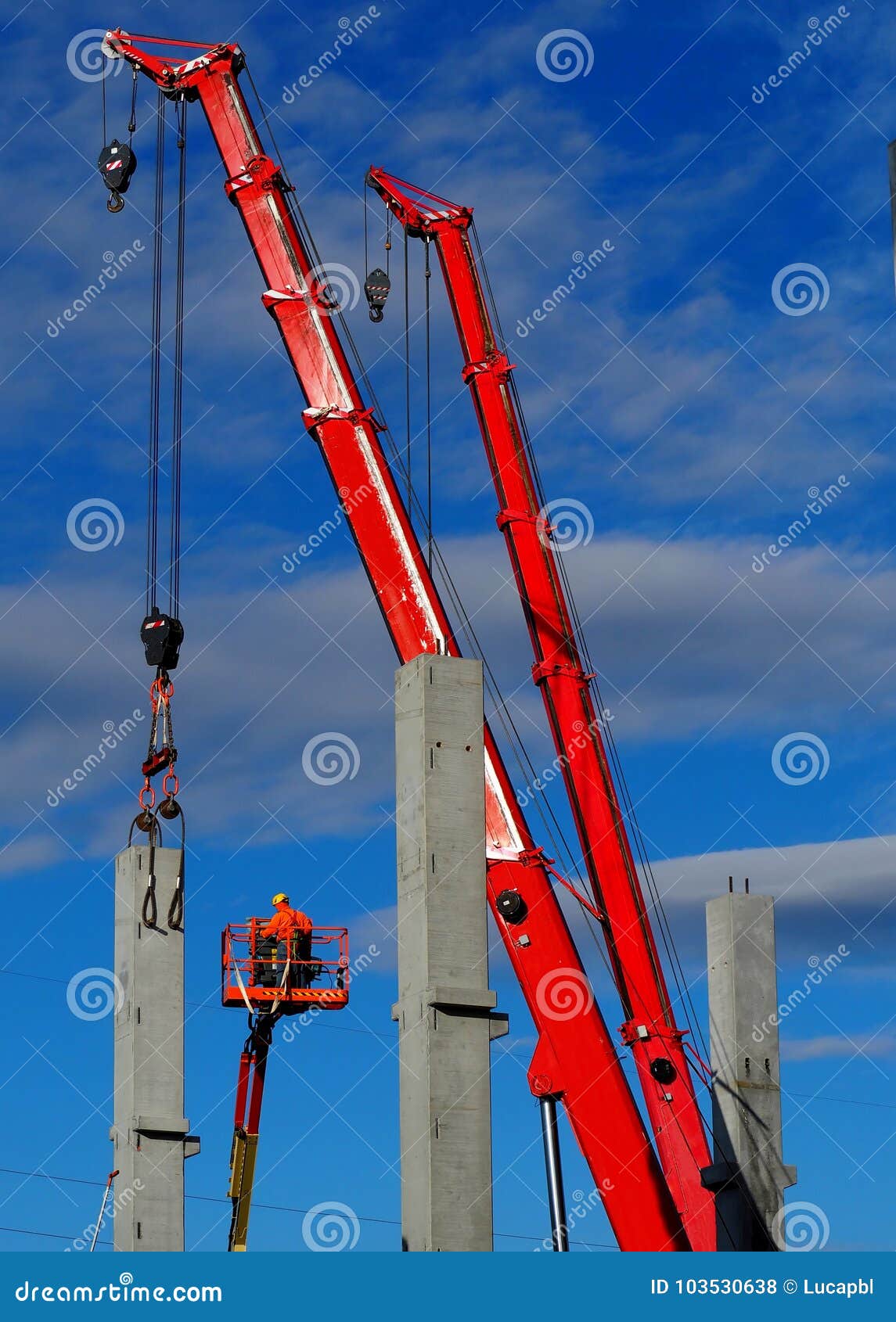 Building Activity. Two Telescopic Cranes and a Cherry Pickers Install ...