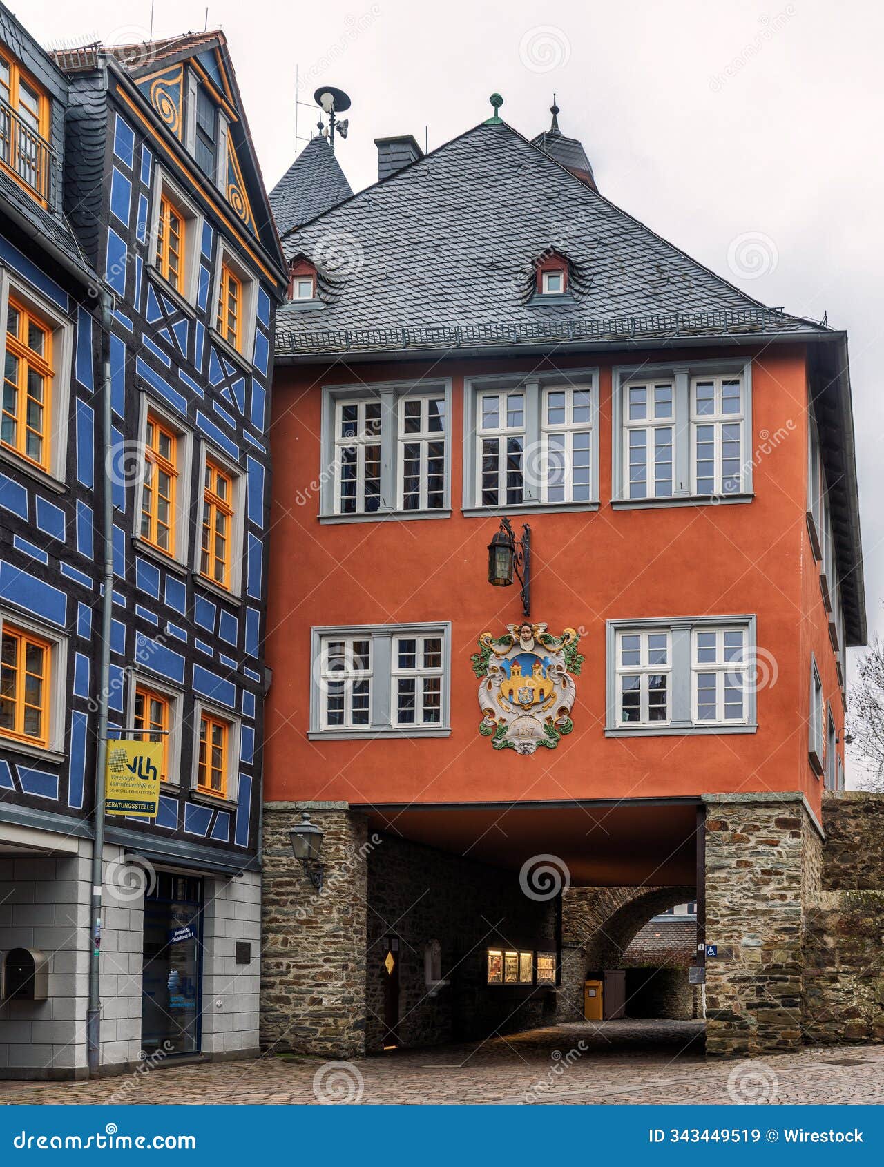 Building with an Arched Entrance Flanked by Two Adjacent Structures in ...