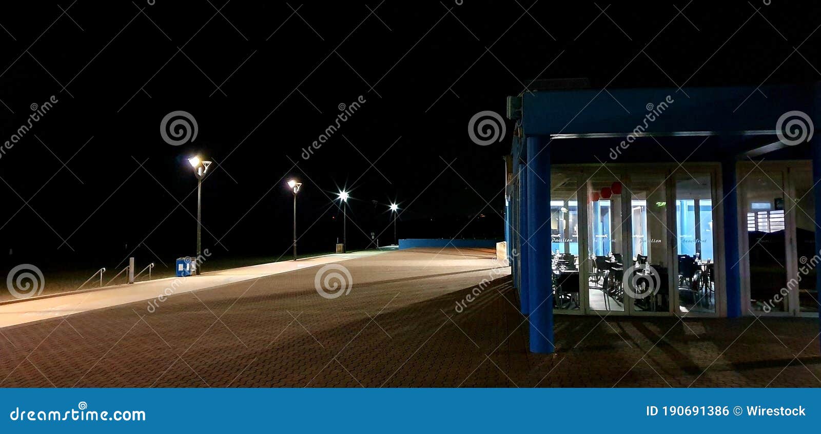 Building by the Beach Captured at Night with the Switched on City ...