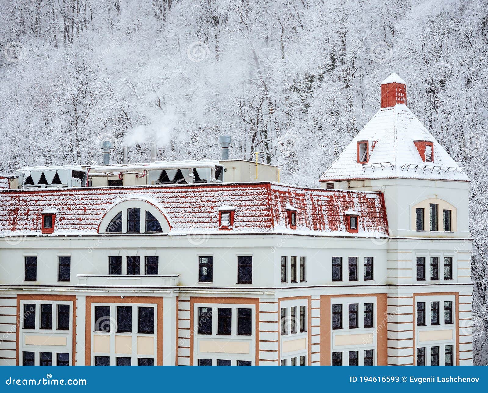 Building with a Cone Tower Against a Background of Snow-covered Trees ...