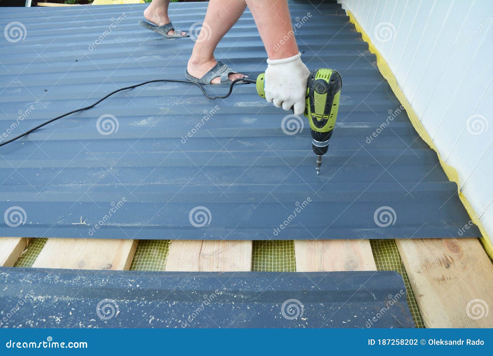 A Building Constructor is Installing Lightweight Metal Roofing Sheet ...