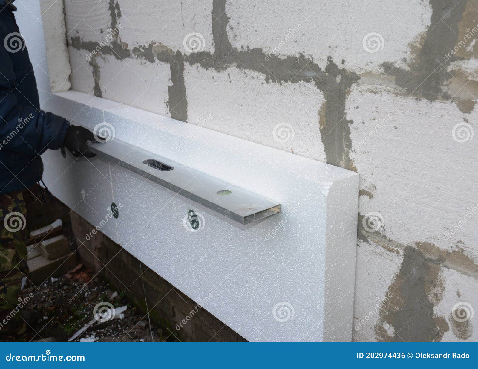 A Building Contractor Installing External Wall Polystyrene Boards ...