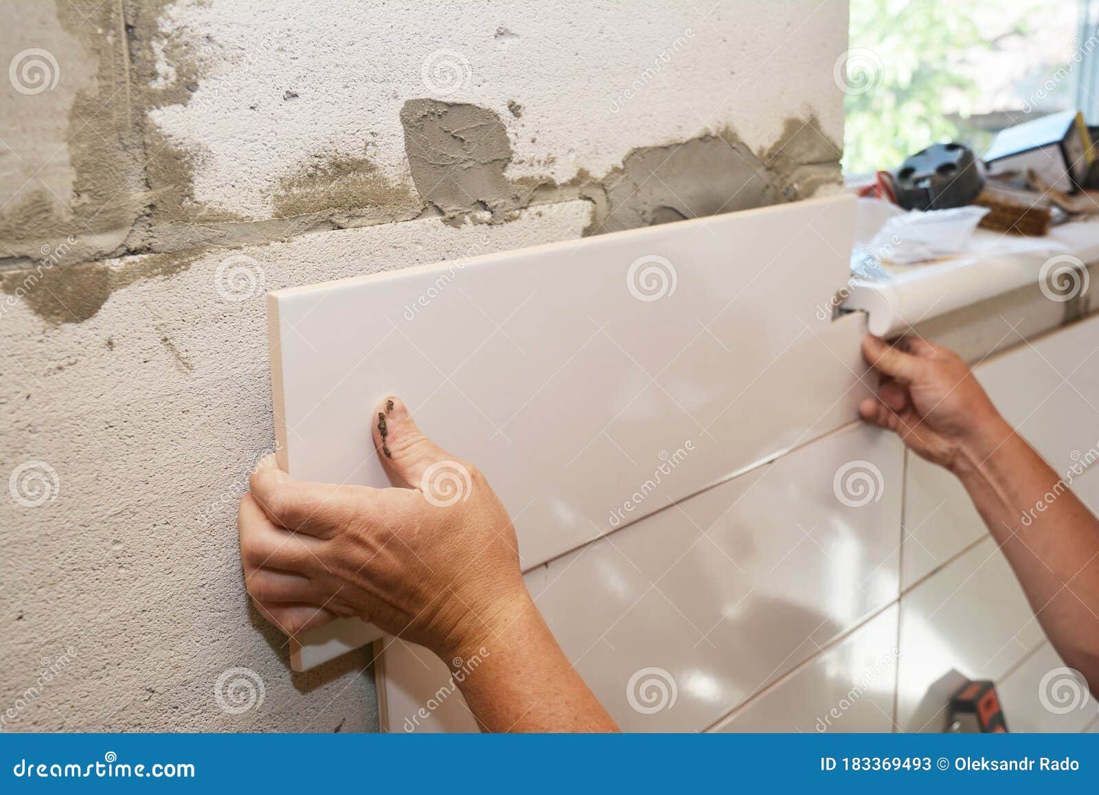 A Building Contractor is Installing White Rectangle Large Ceramic Tiles ...