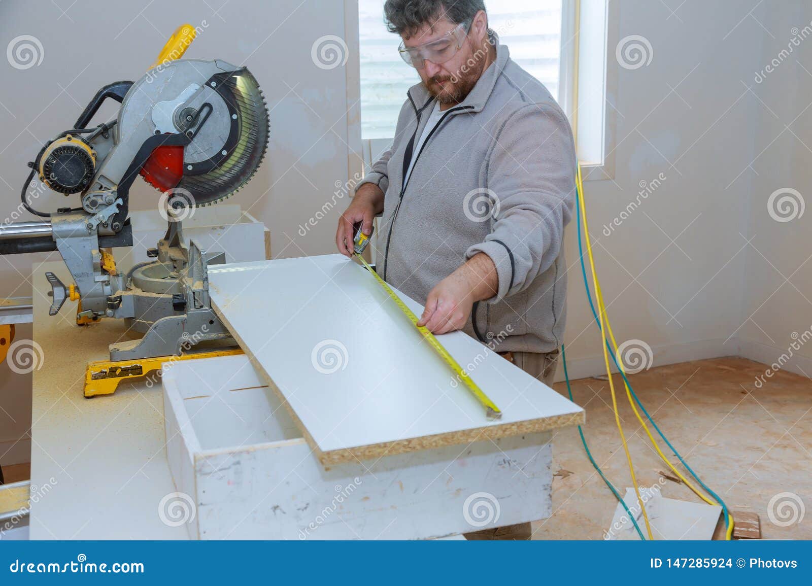 Building Contractor Worker Using Measuring and Marking a Board before ...