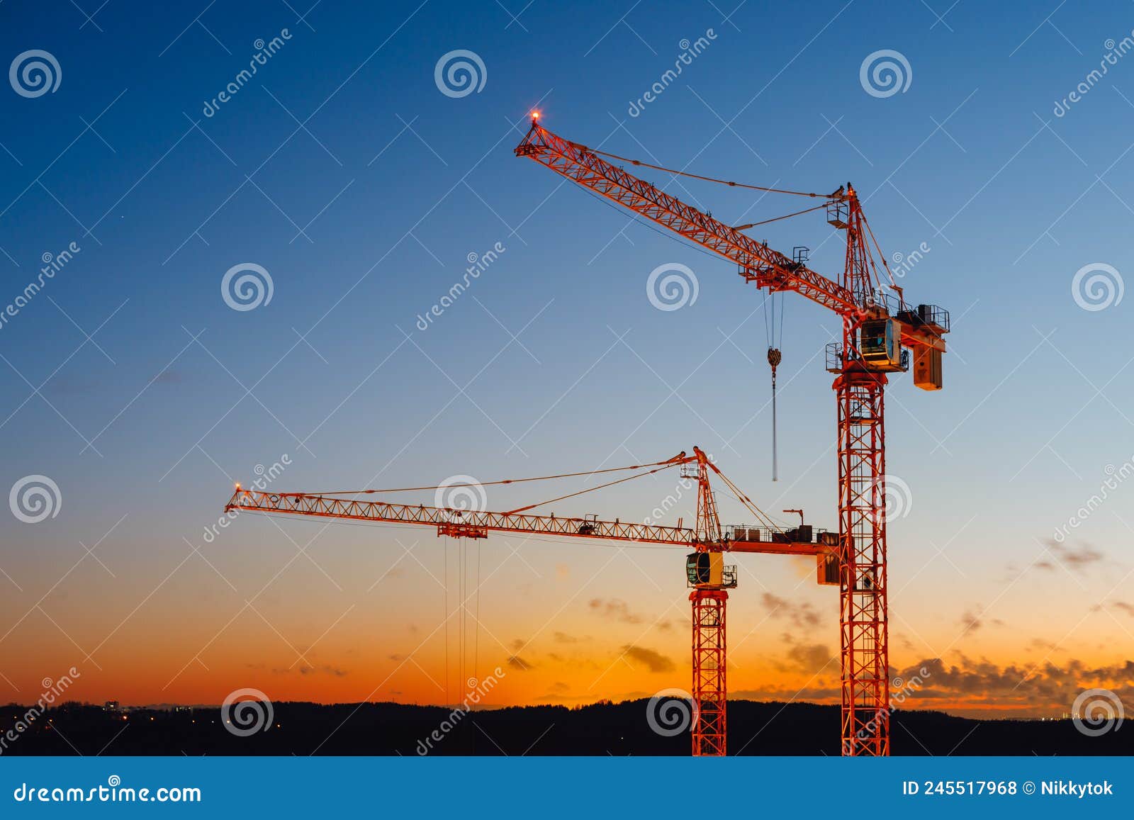 Building Cranes At Front Of A Multi-storey Uilding Under Construction ...