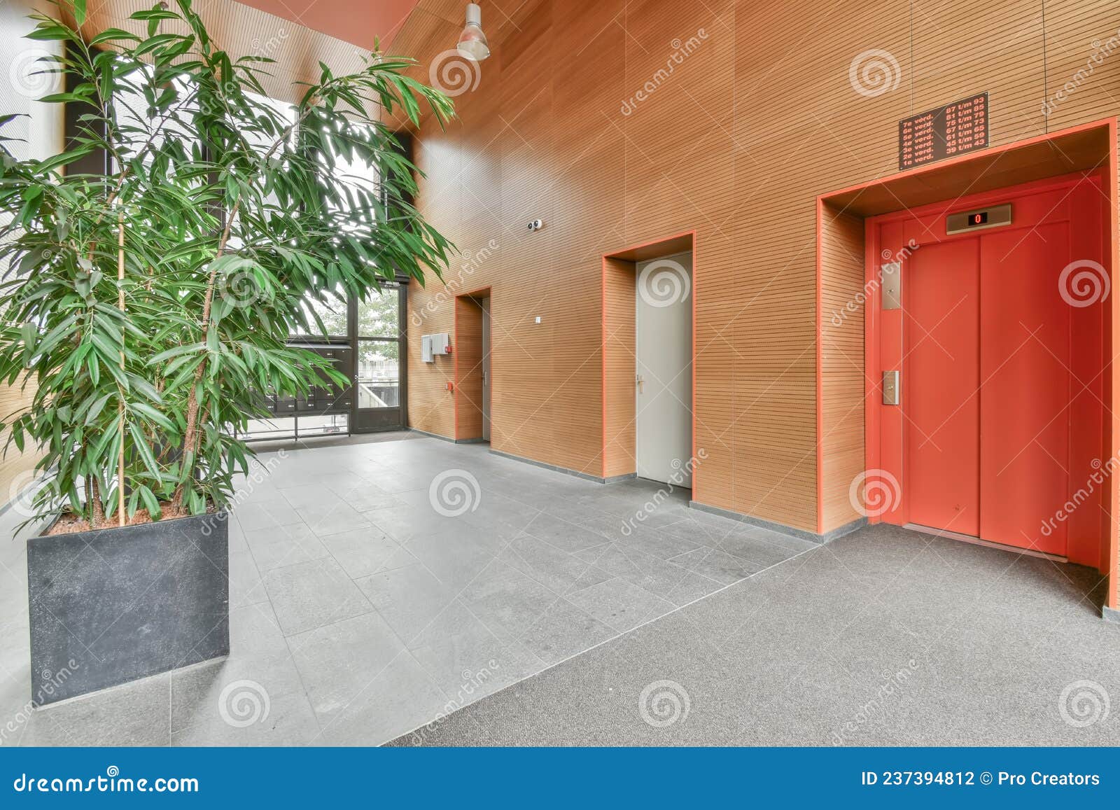 Building Entrance with Bright Red Elevator Stock Photo - Image of real ...