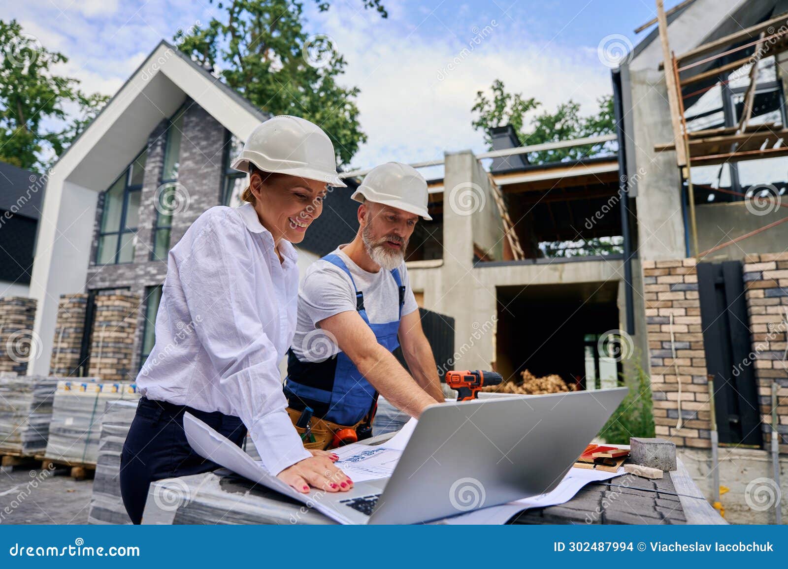 Building Experts Discussing New Architectural Drawings Outdoors Stock ...