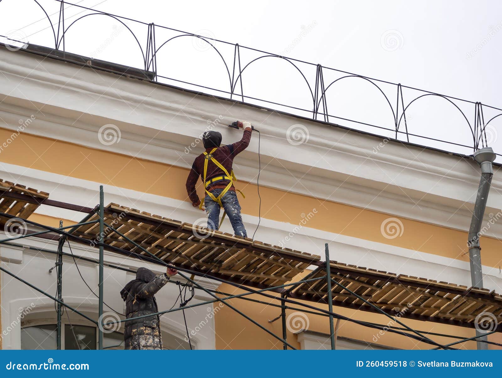 Building Facade Renovation. the Worker Works the Surface with a Power ...
