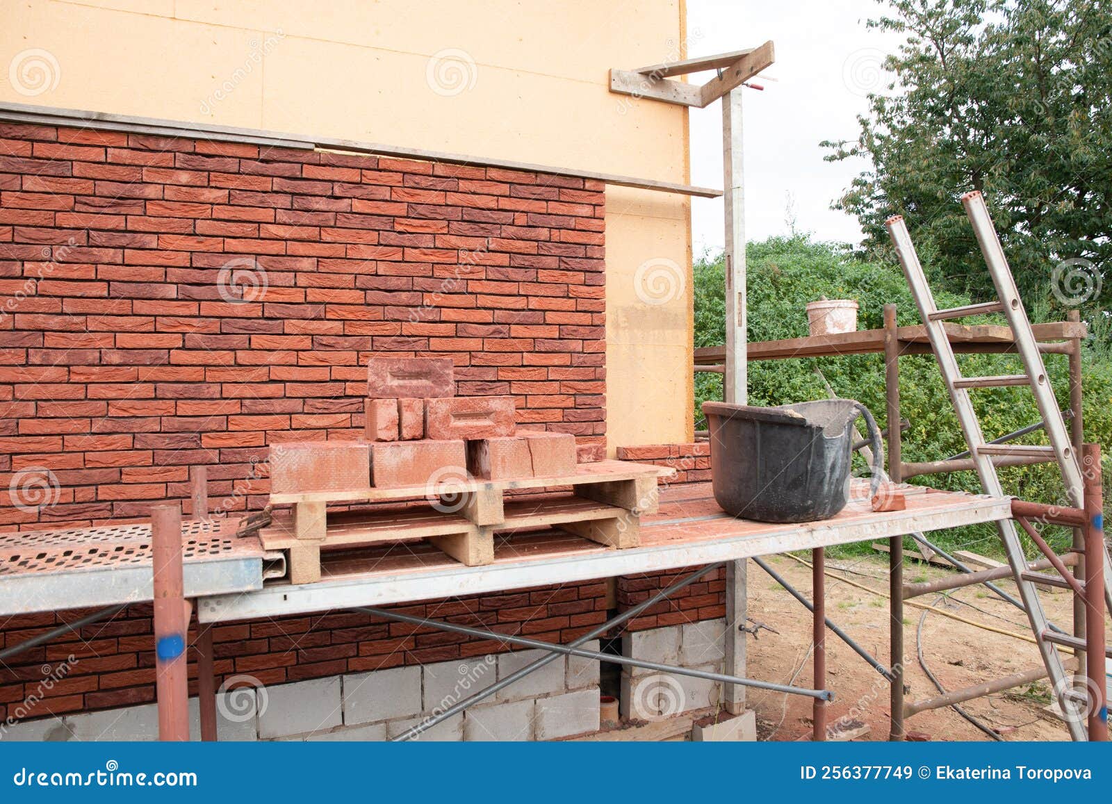 Building a House Supporting Structure for Laying Bricks Around a Wooden ...