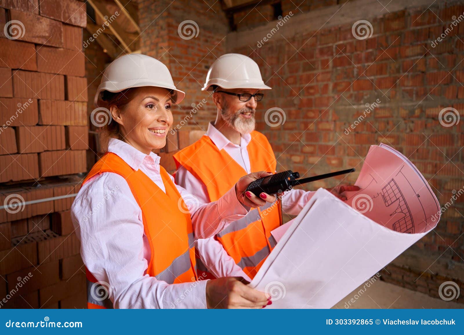Building Inspector and Contractor are Using Blueprints during Site ...