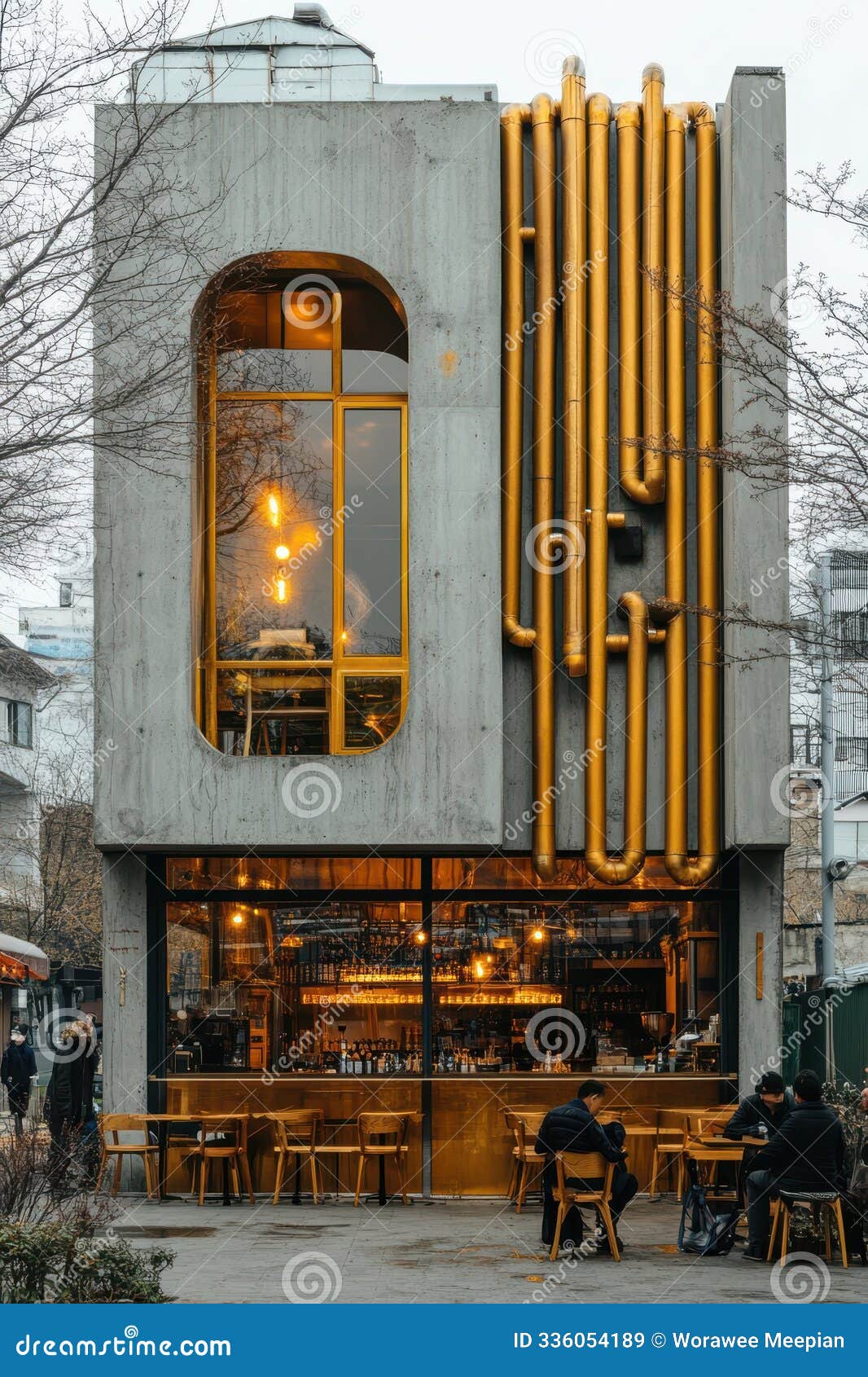 A Building with a Lot of Windows and a Gold Pipe Design on the Side ...