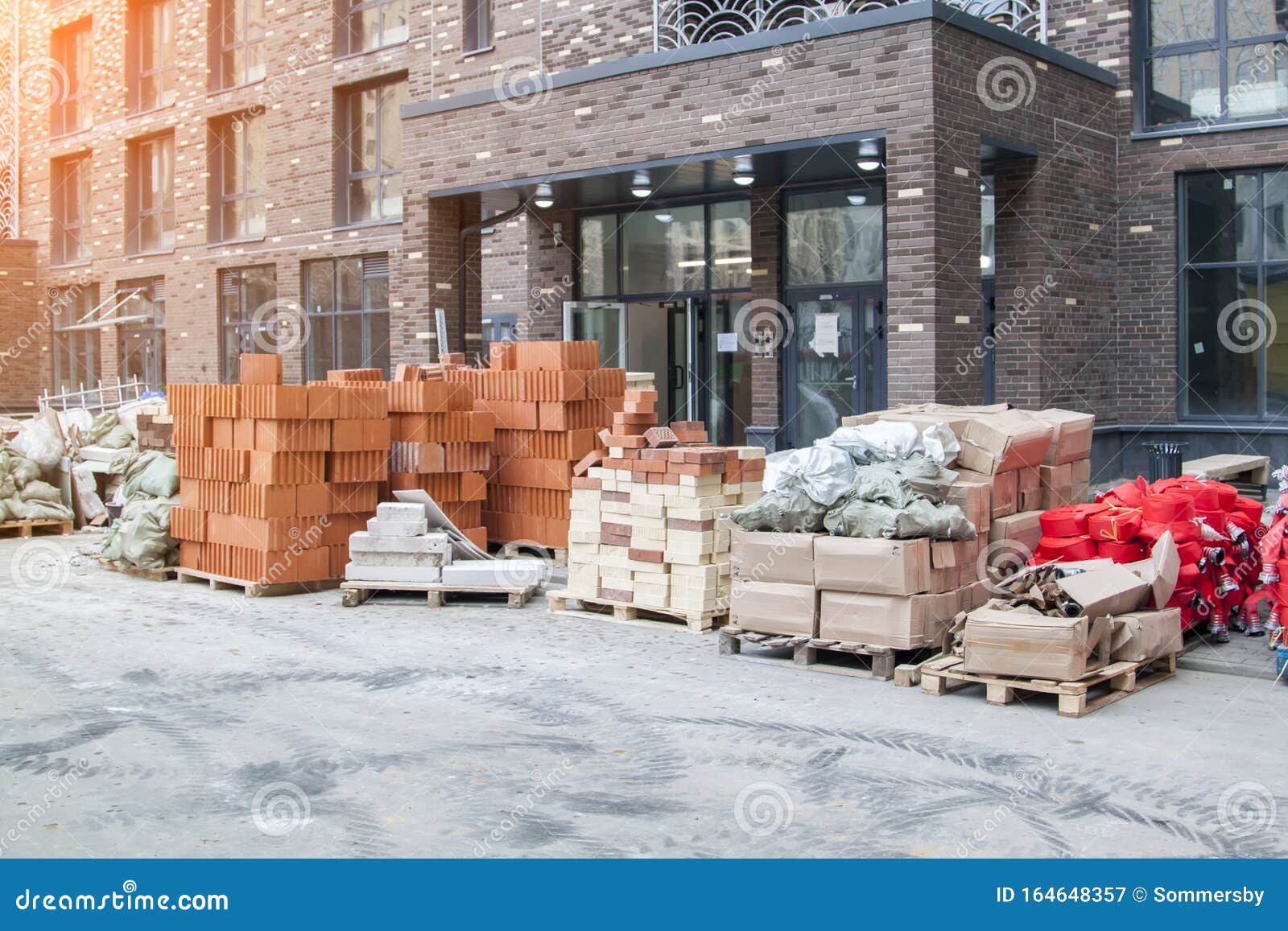 Building Materials, Pallets of Bricks and Fire Hoses are Stacked in ...