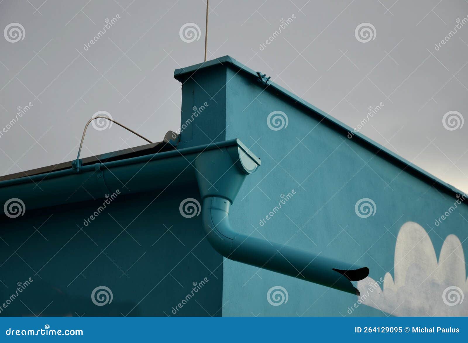 A Building Painted Turquoise, Including a Gutter and a Water Spout ...