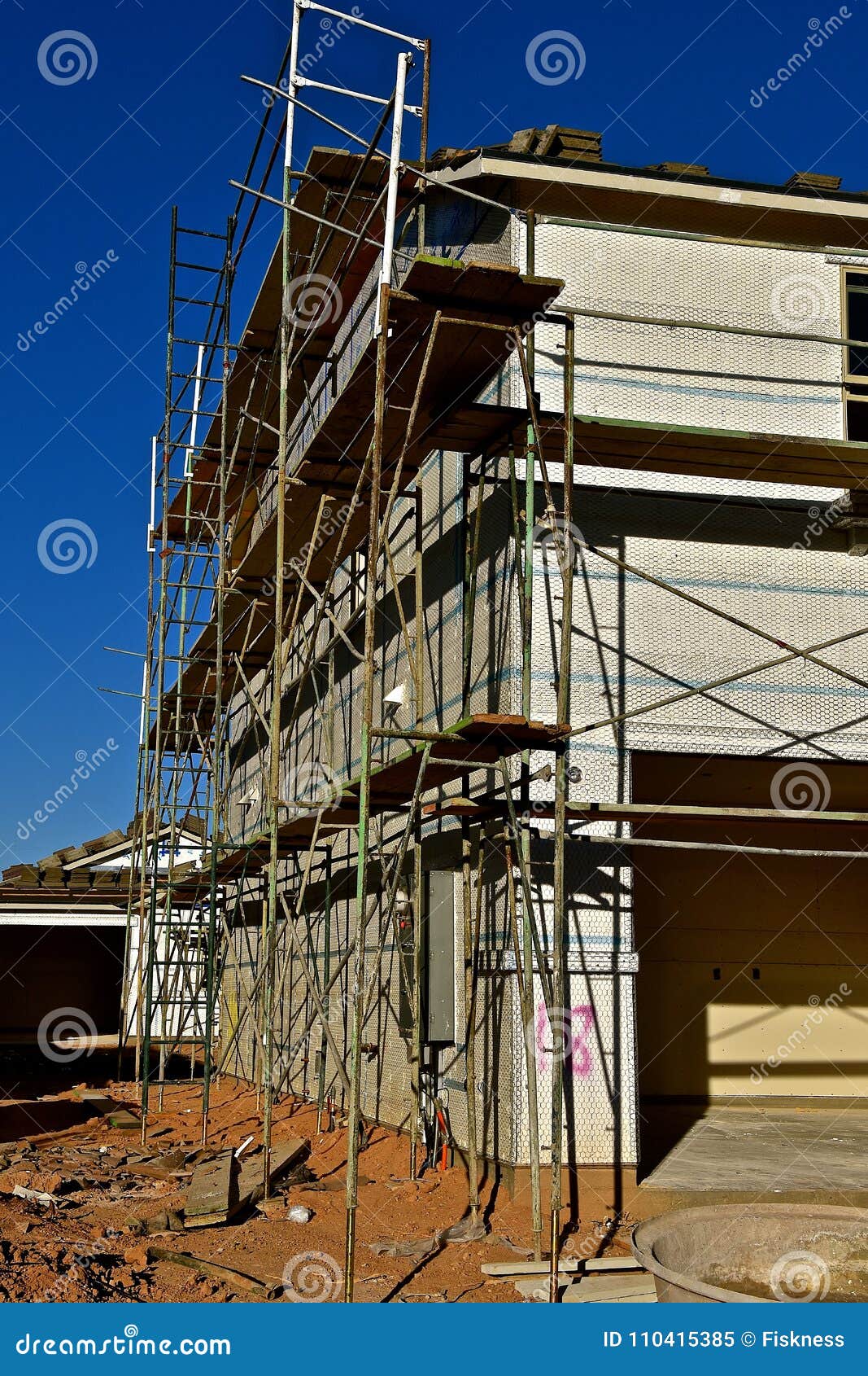 Side Profile of a House Under Construction with Scaffolding and Tile ...