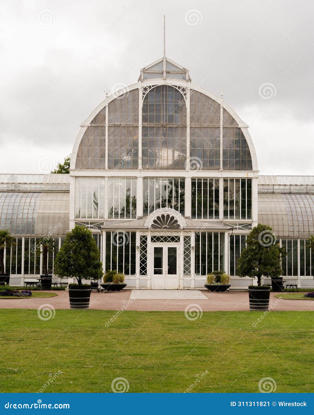 A Building with Some Big Windows in it, with Lots of Plants and Trees ...