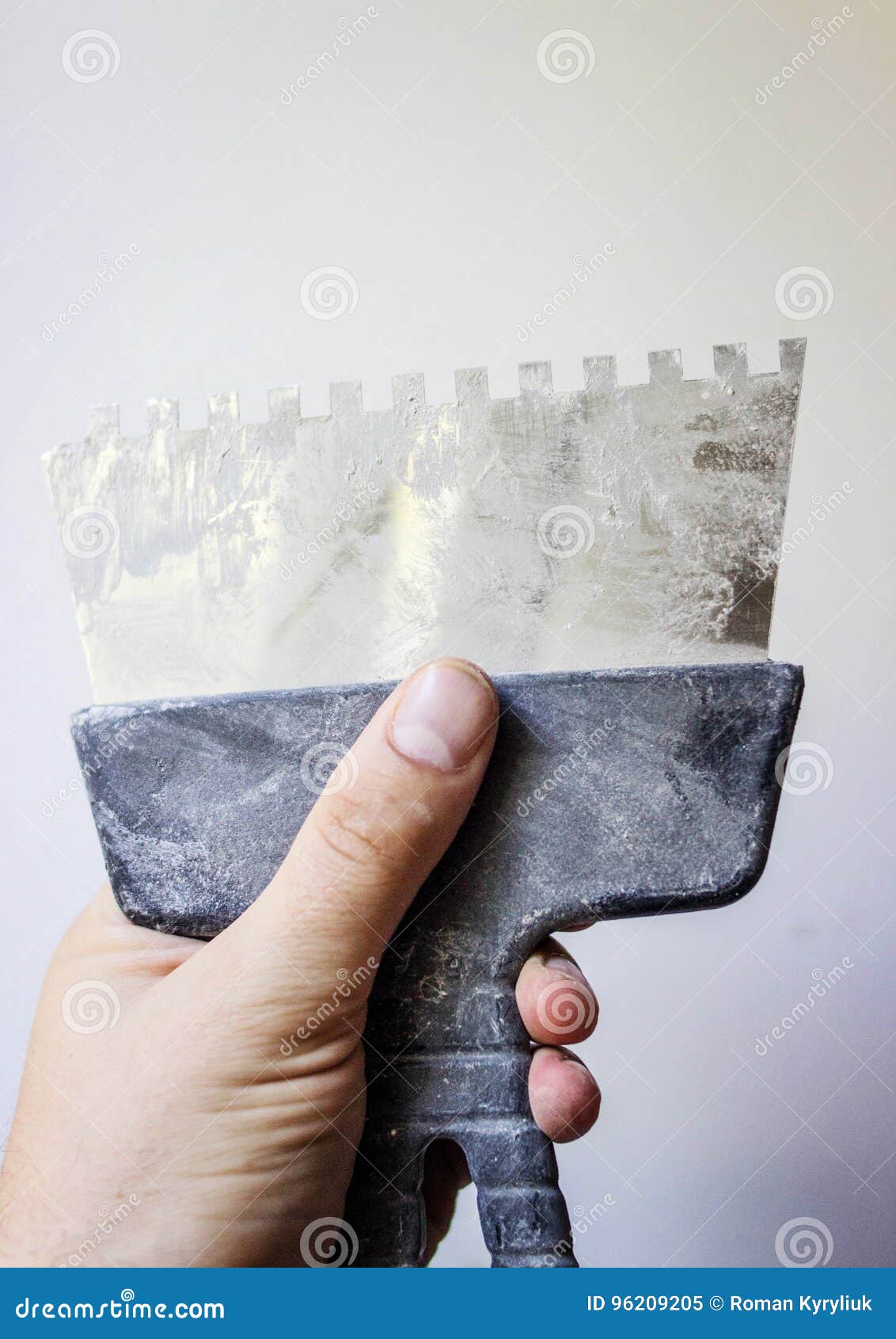 Building spatula in hand stock image. Image of renovation - 96209205