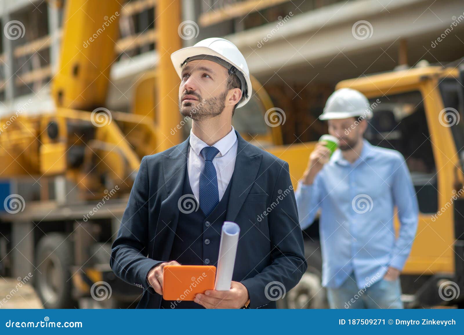 Building Supervisor Holding Tablet, Foreman Standing Behind Him ...