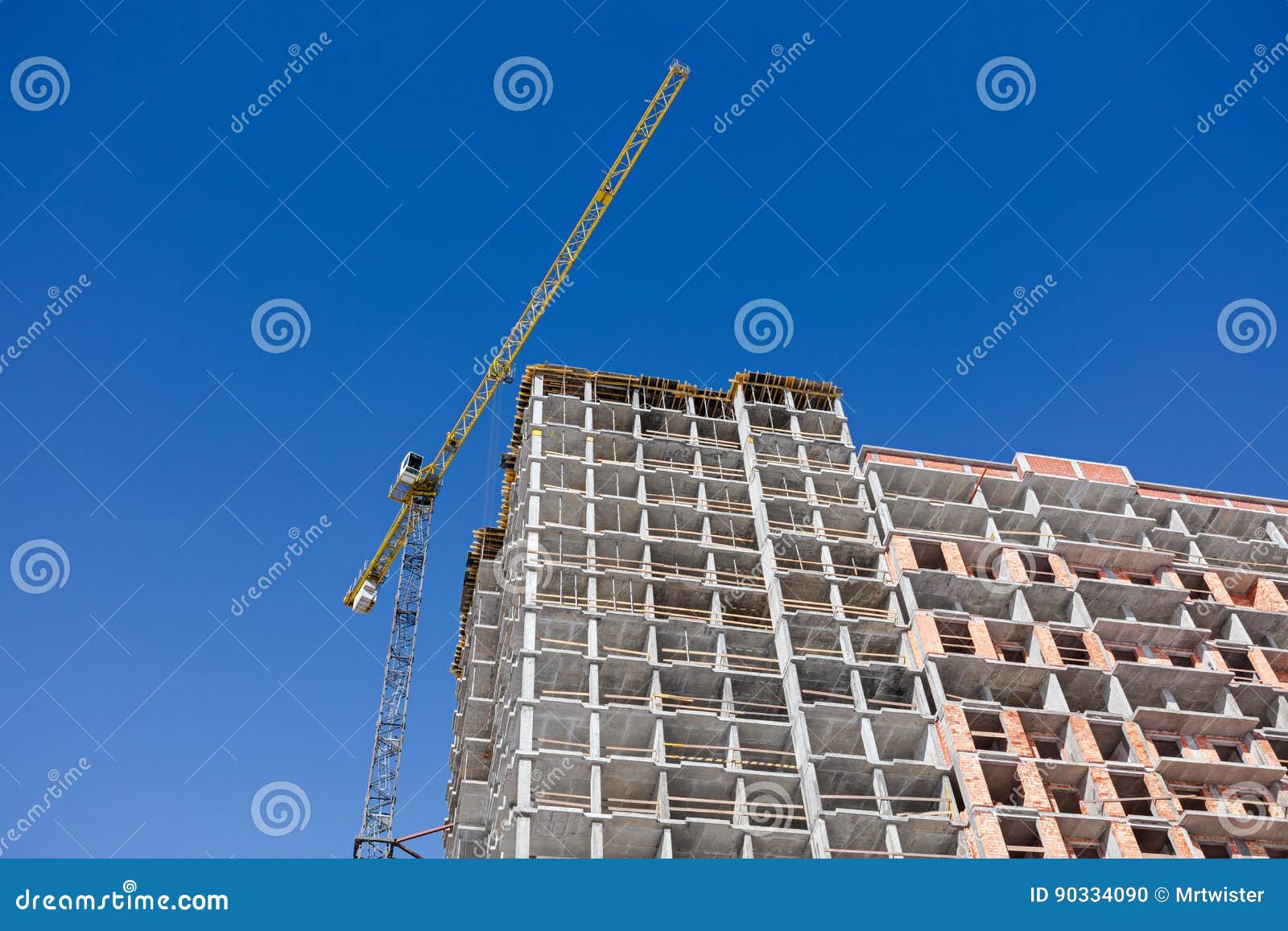Building Under Construction with Crane Operating Against Blue Sk Stock ...