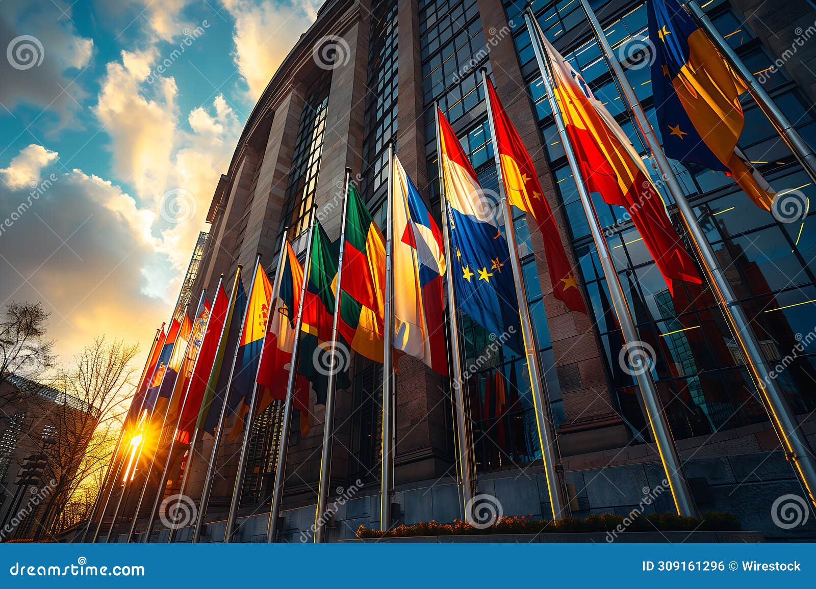 The Building is Very Tall and Has Flags Flying in Front Stock Photo ...