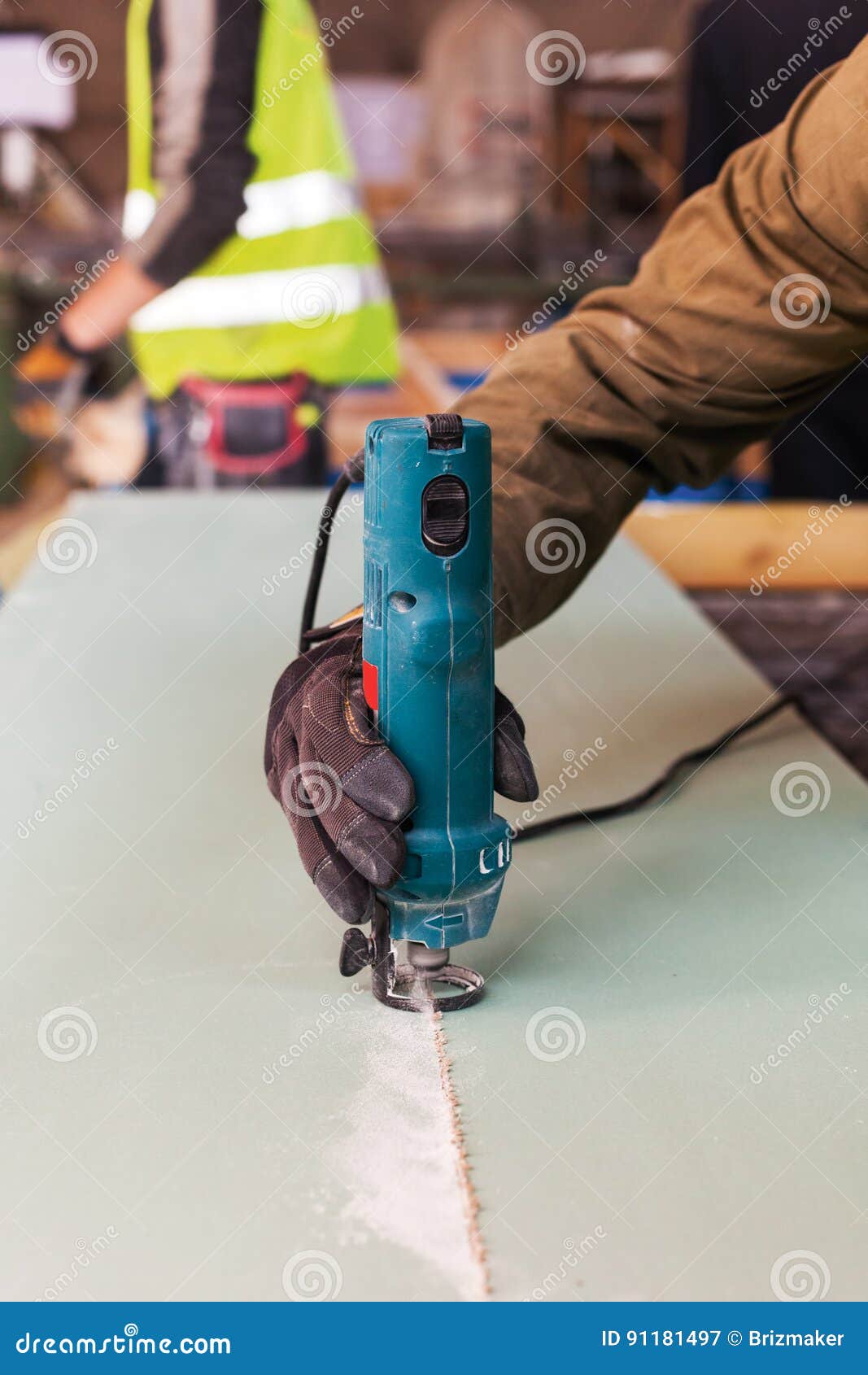 Building a Wall for Frame House. Worker Use Laminate Trimmer for ...