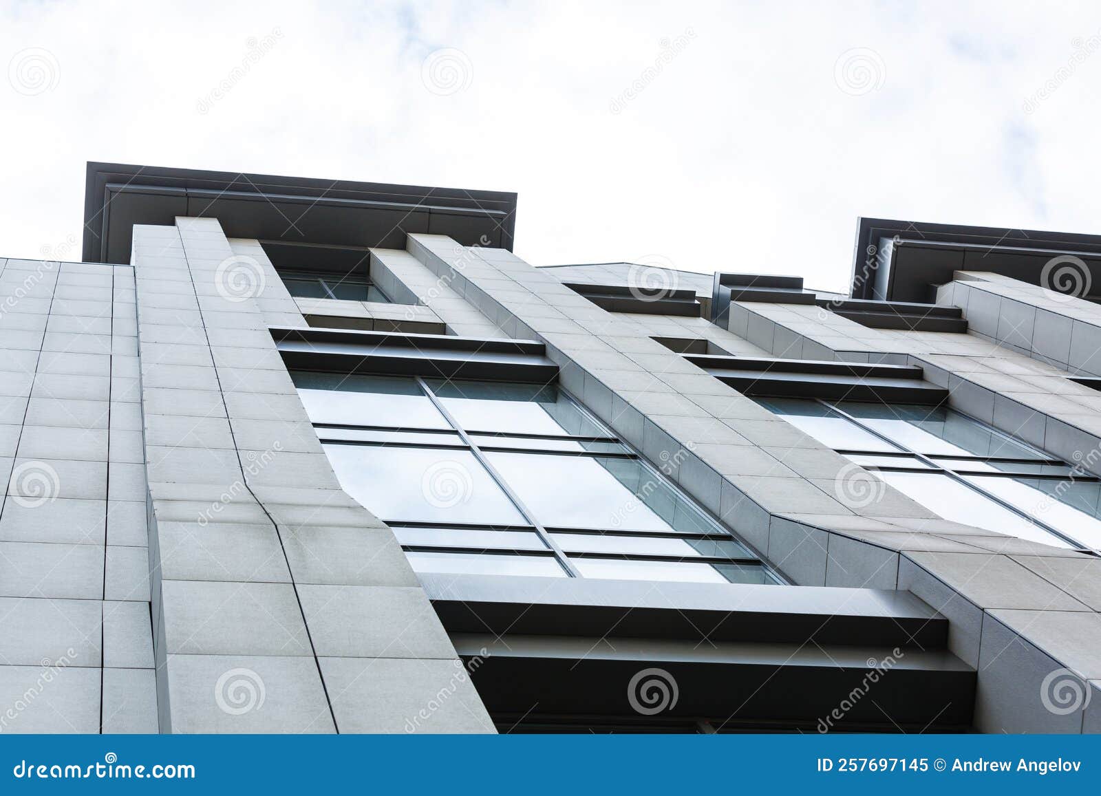 Building with Windows and Grey Walls. Windows are Reflecting Light ...