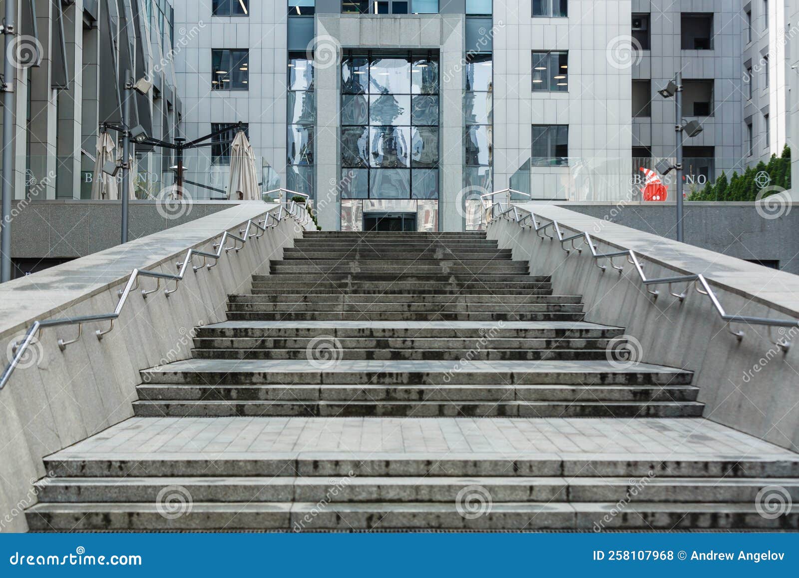Building with Windows and Grey Walls. Windows are Reflecting Light ...