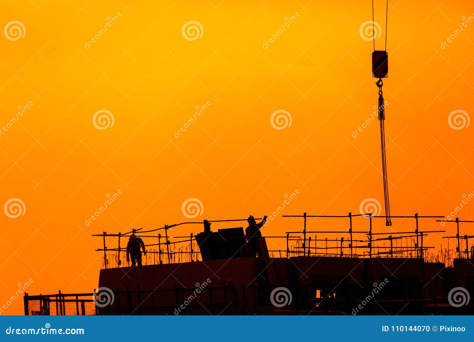 Building Workers Working on a Building Under a Sunset Stock Photo ...