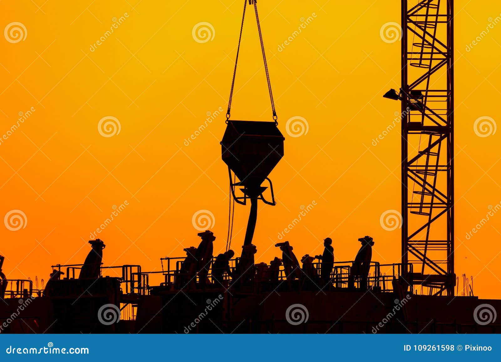 Building Workers Working on a Building Under a Sunset Stock Photo ...