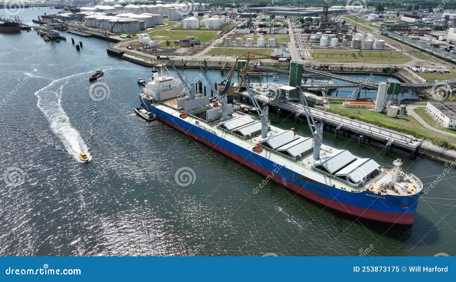 Bulk Carrier Ship at Port Offloading Cargo and Commodities by Shore ...