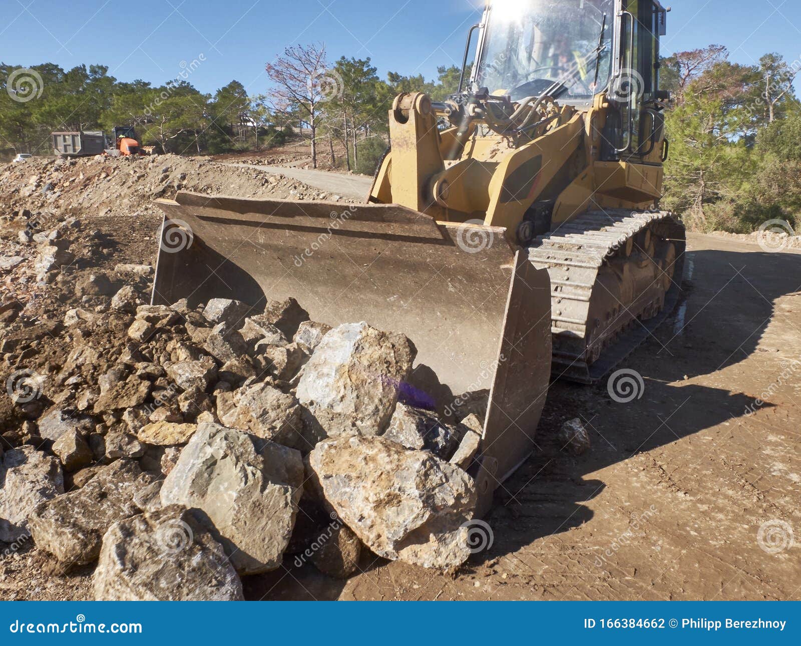 Bulldozer is Moving Boulders during Road Construction Works Stock Photo ...