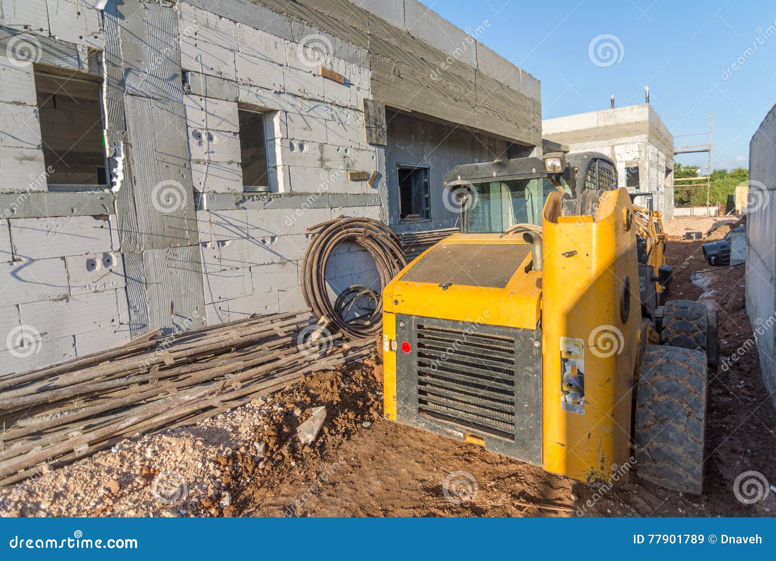 Bulldozer and Brick and Concrete House Under Construction Editorial ...
