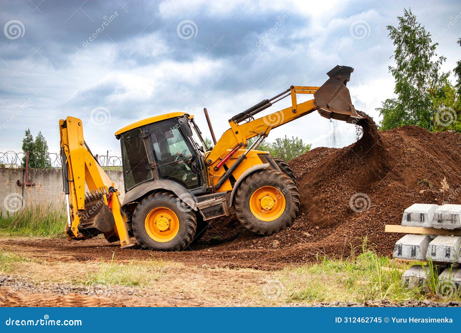 A Bulldozer or a Loader Actively Digging into a Large Pile of Dirt at a ...