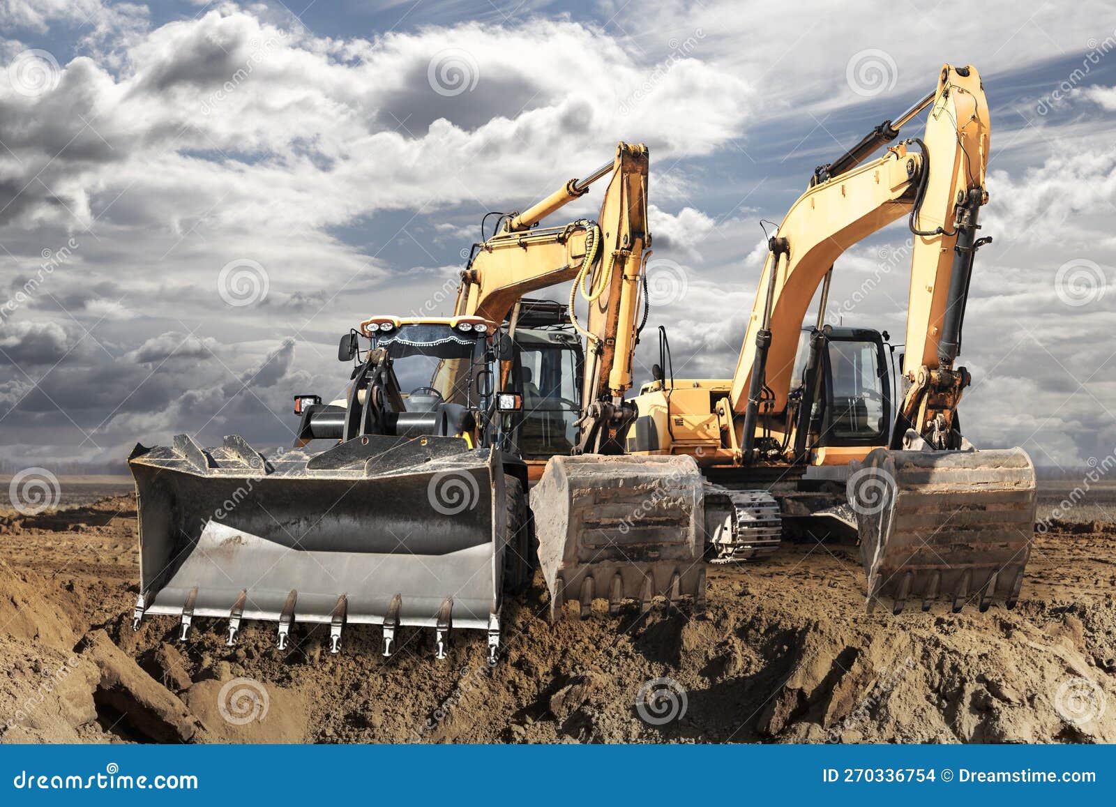 Bulldozer or Loader Moves the Earth at the Construction Site Against ...