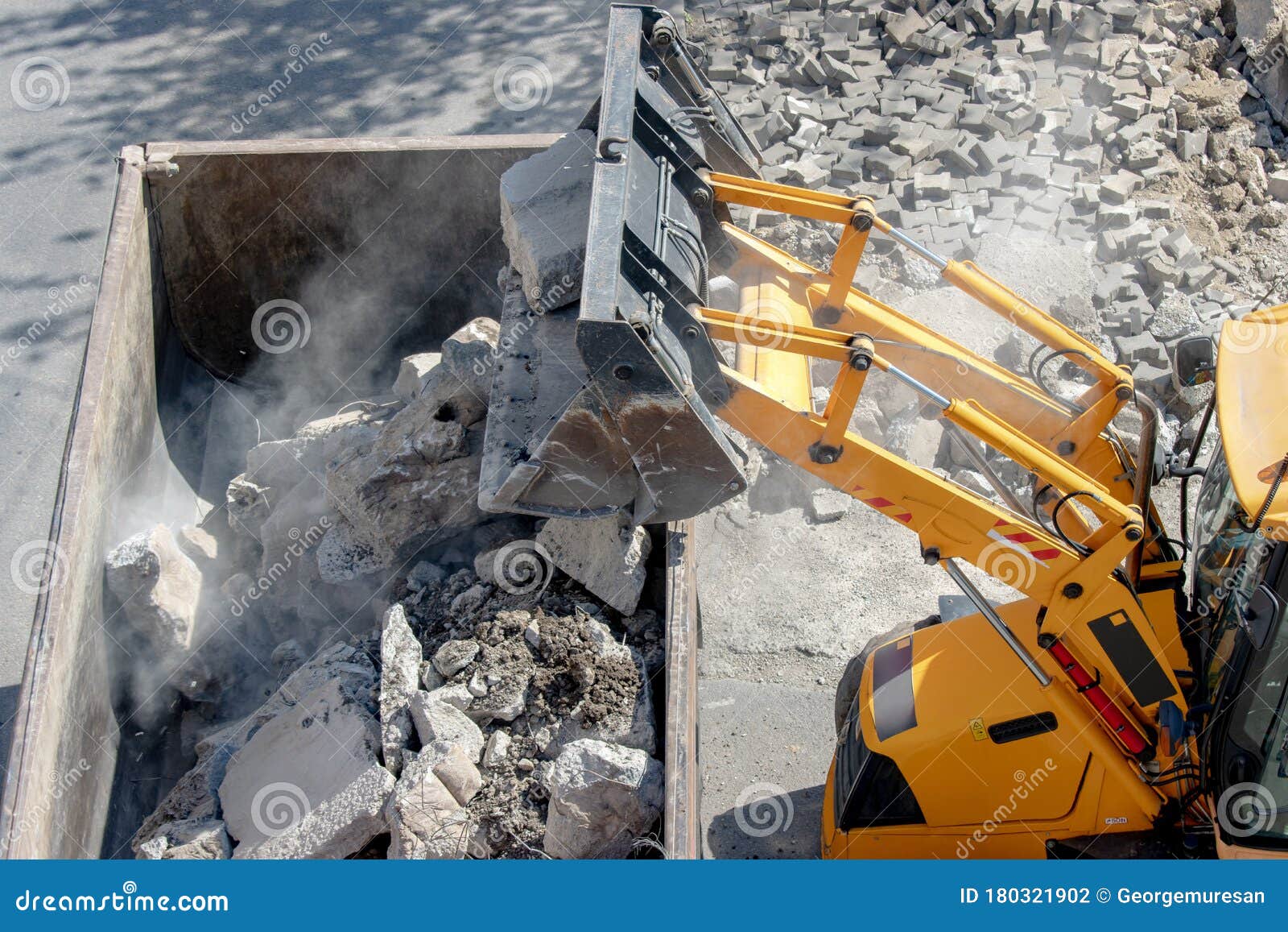 Bulldozer Loader Uploading Concrete Debris into Dump Truck Stock Photo ...