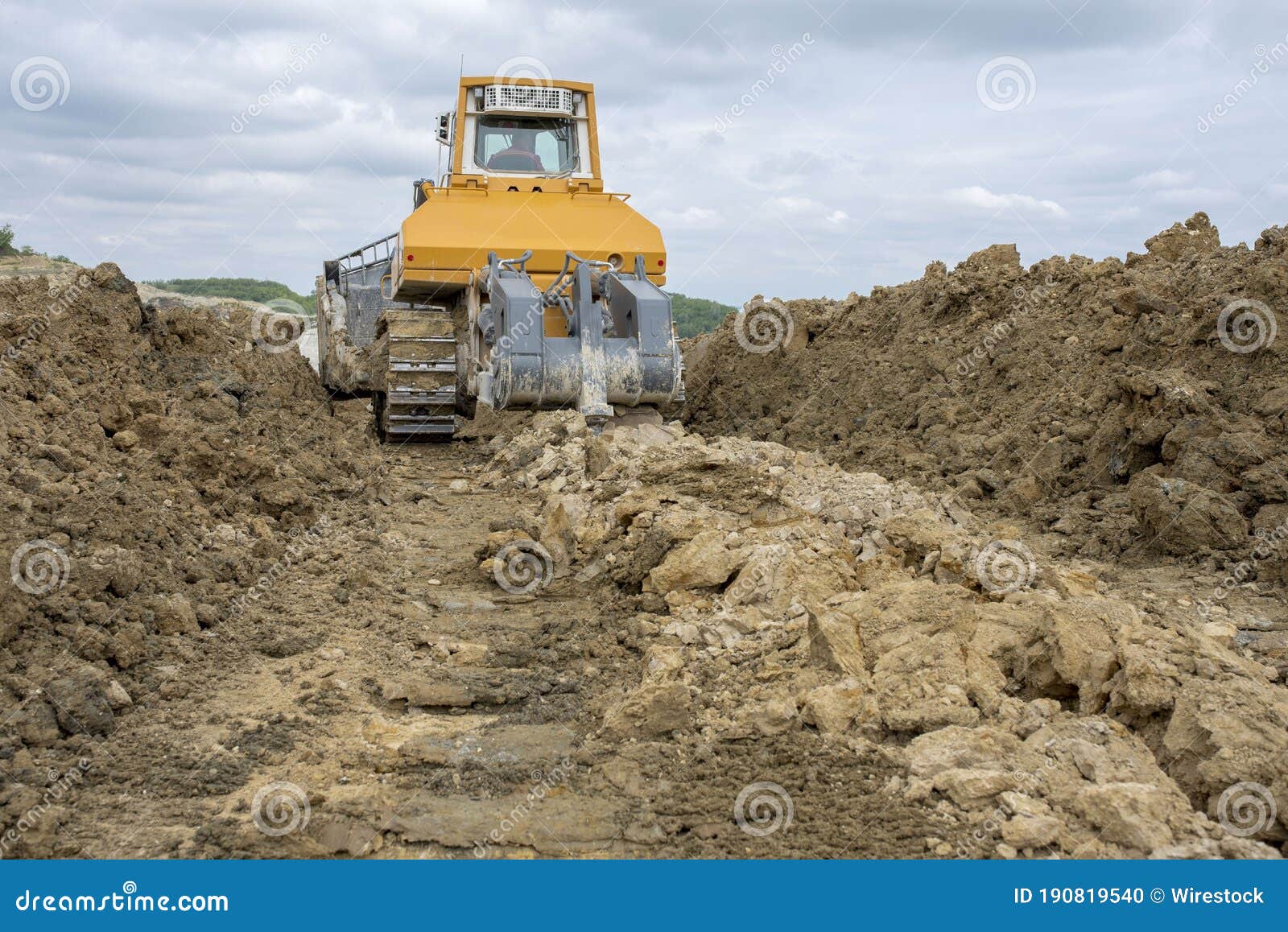 Bulldozer Moving Soil and Rocks at a Construction Site Stock Photo ...