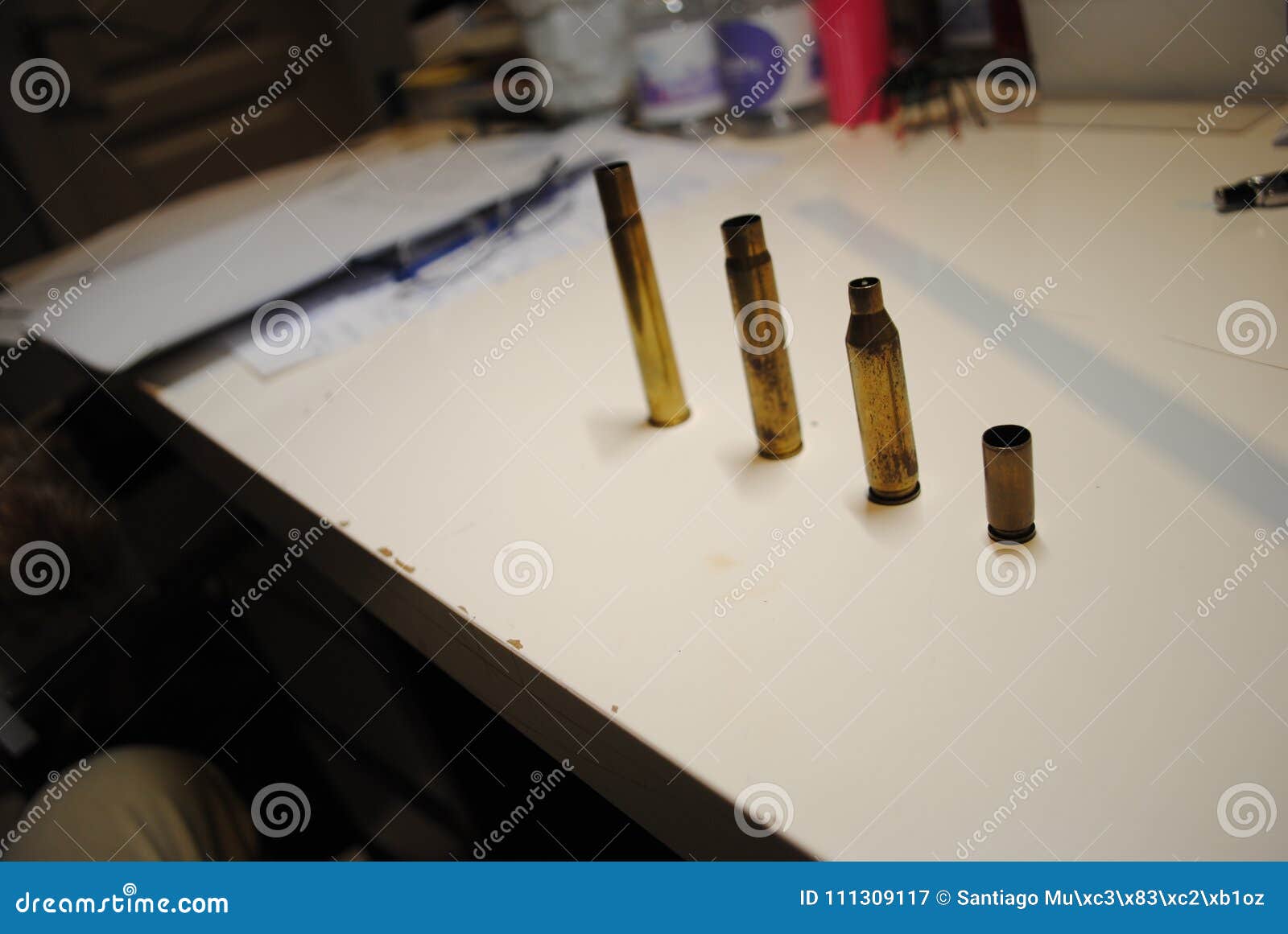4 bullets on a desk stock image. Image of bullets, four - 111309117