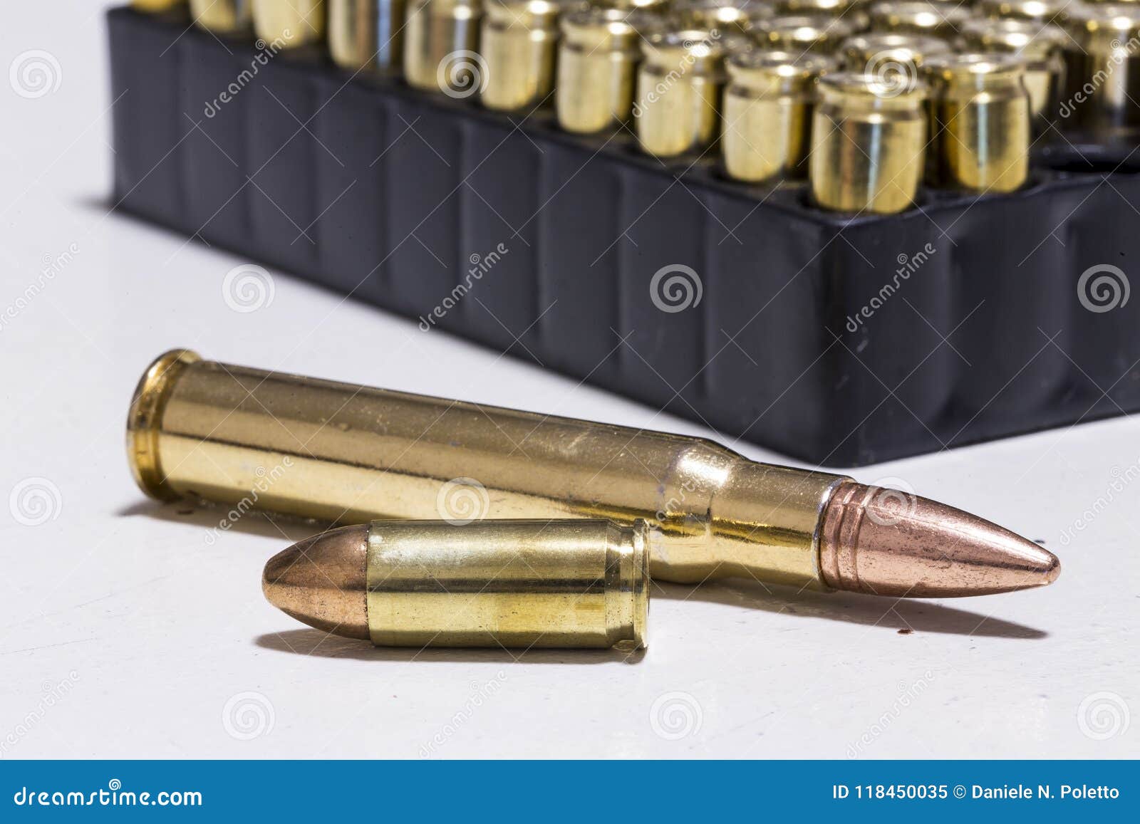 2 Bullets of Different Caliber in Front of Bullets Stock Image - Image ...