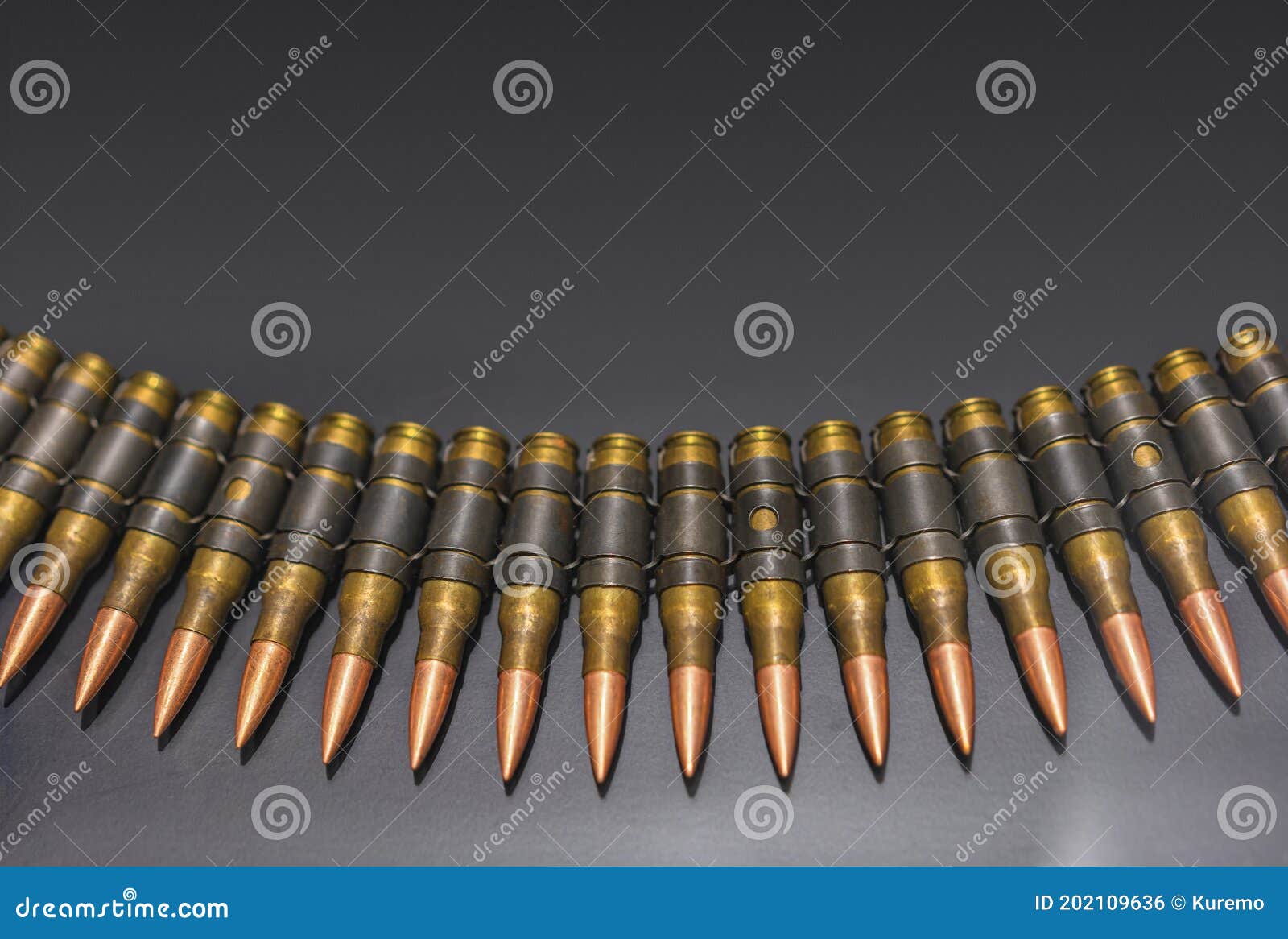 Bullets of Linked Ammunition Lined Up in Row on a Black Background ...