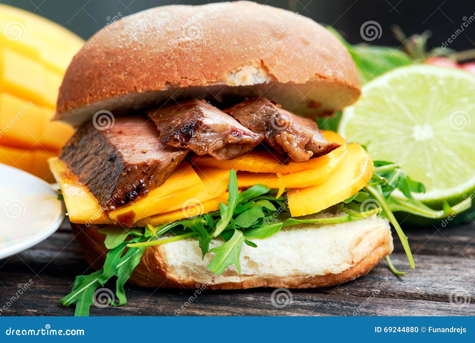 Bun with Grilled Roast Beef, Mango and Arugula. Stock Photo - Image of ...