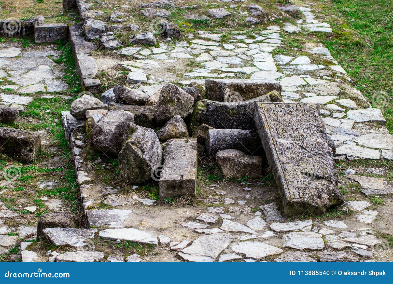 A Bunch of Ancient Stone Blocks Lying on the Grass Stock Photo - Image ...
