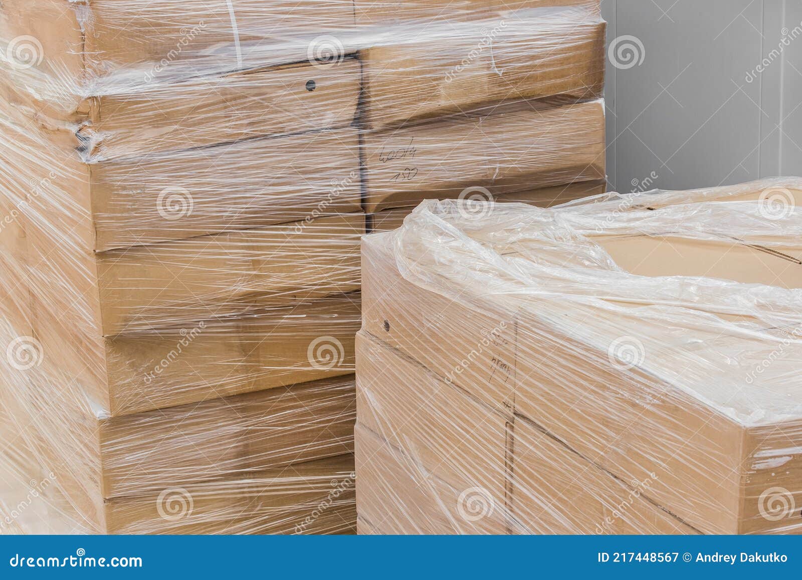 A Bunch of Cardboard Boxes with Building Materials Packed in Plastic ...