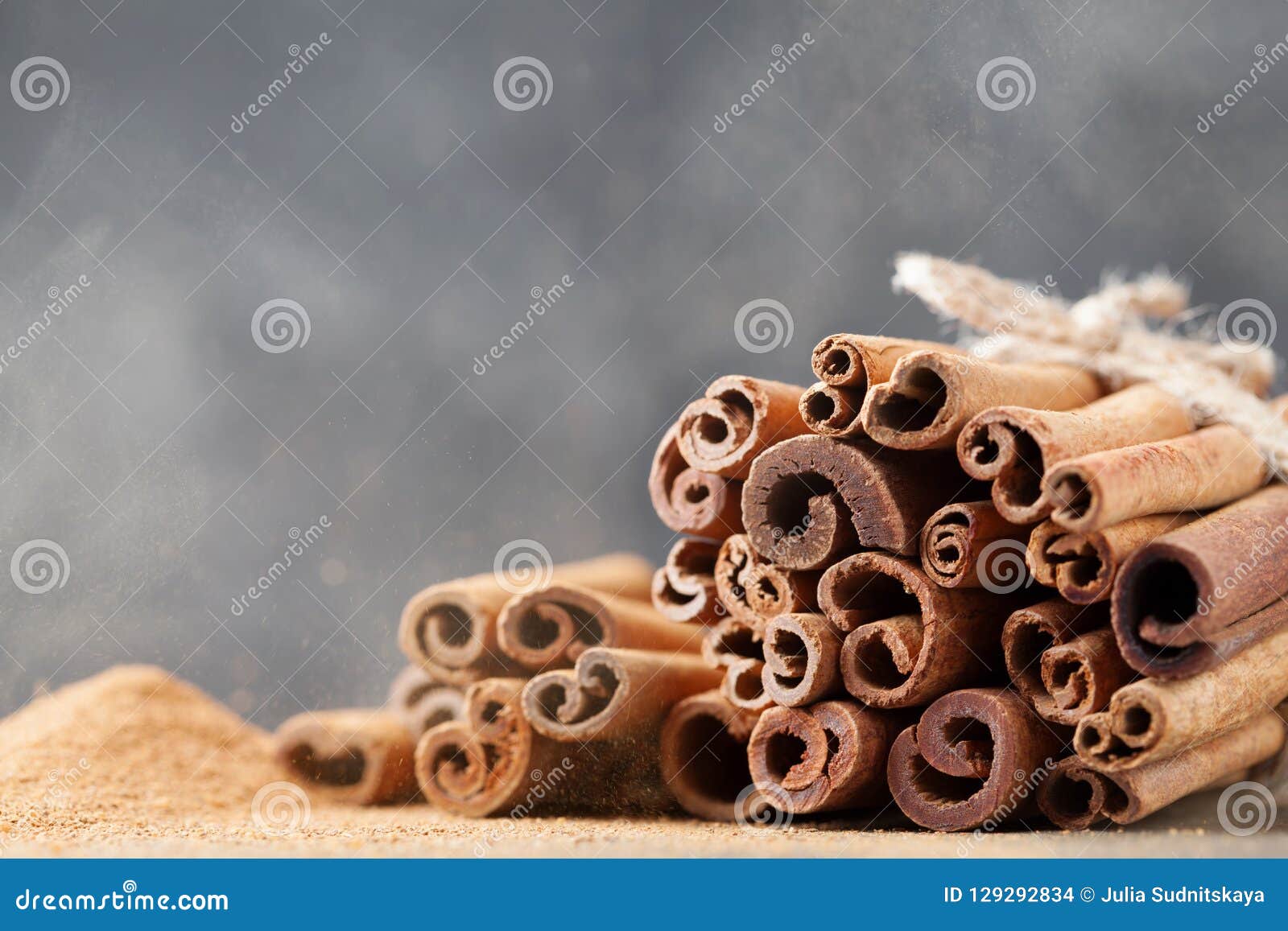 Bunch of Cinnamon Sticks and Ground Cinnamon on Dust Effect Background ...