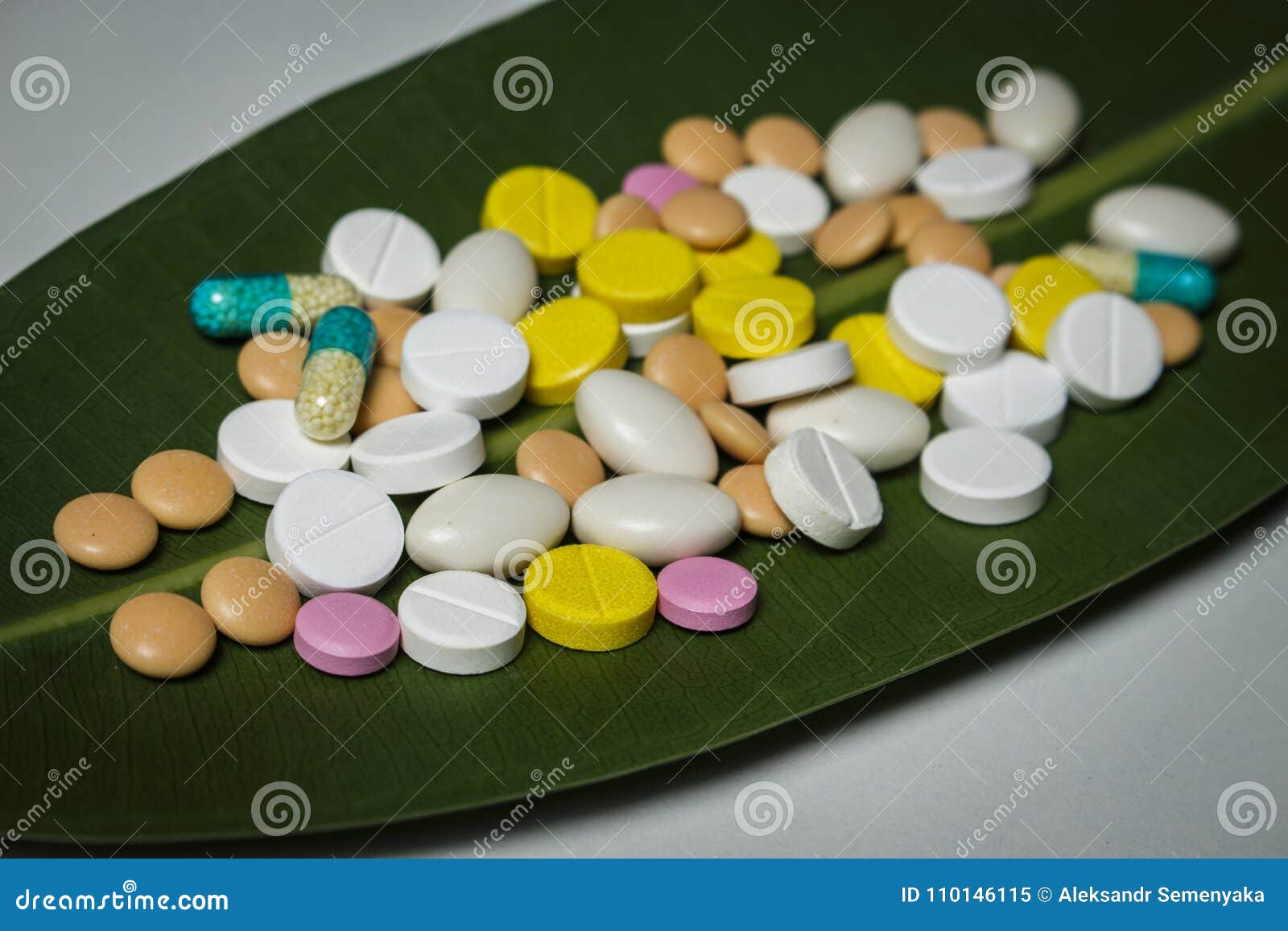 A Bunch of Different Pills on a Green Leaf Stock Image - Image of ...
