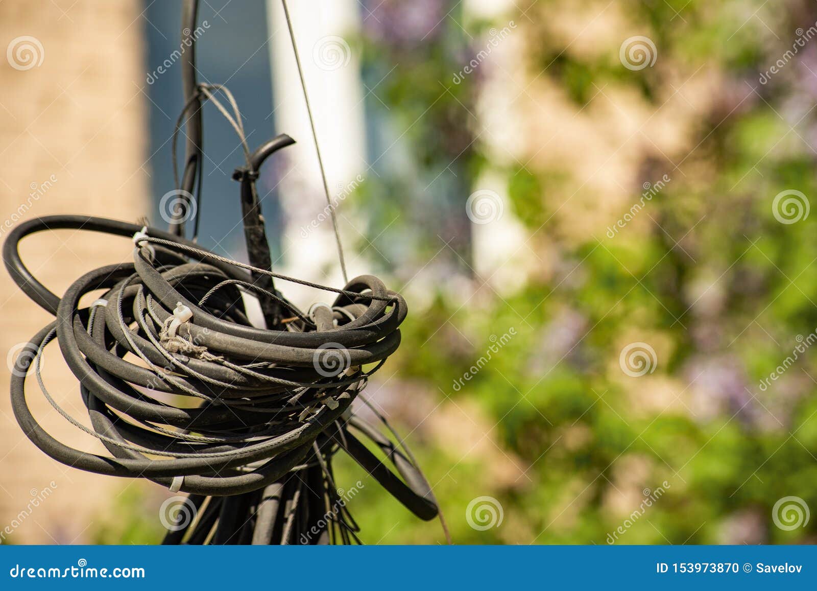 A Bunch Of Electrical Wires Hanging On Blue Background Stock ...