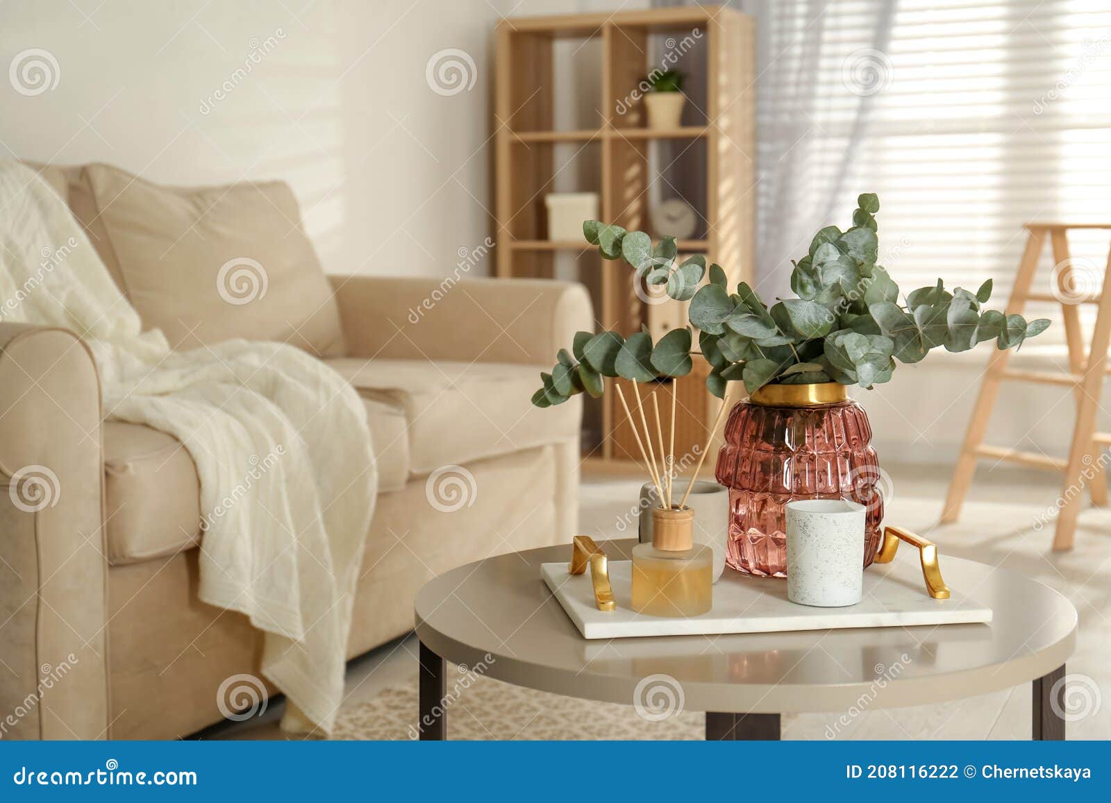 Bunch of Eucalyptus Branches and Oil Diffuser on Table in Living Room ...