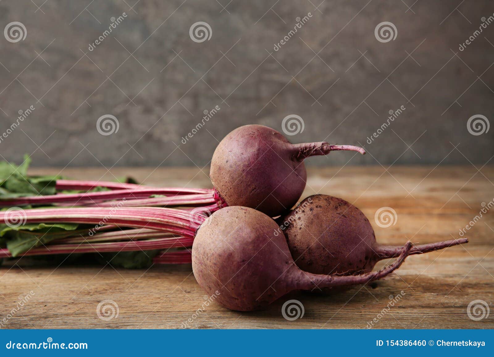 Bunch of Fresh Beets on Wooden Table Against Grey Background. Space for ...